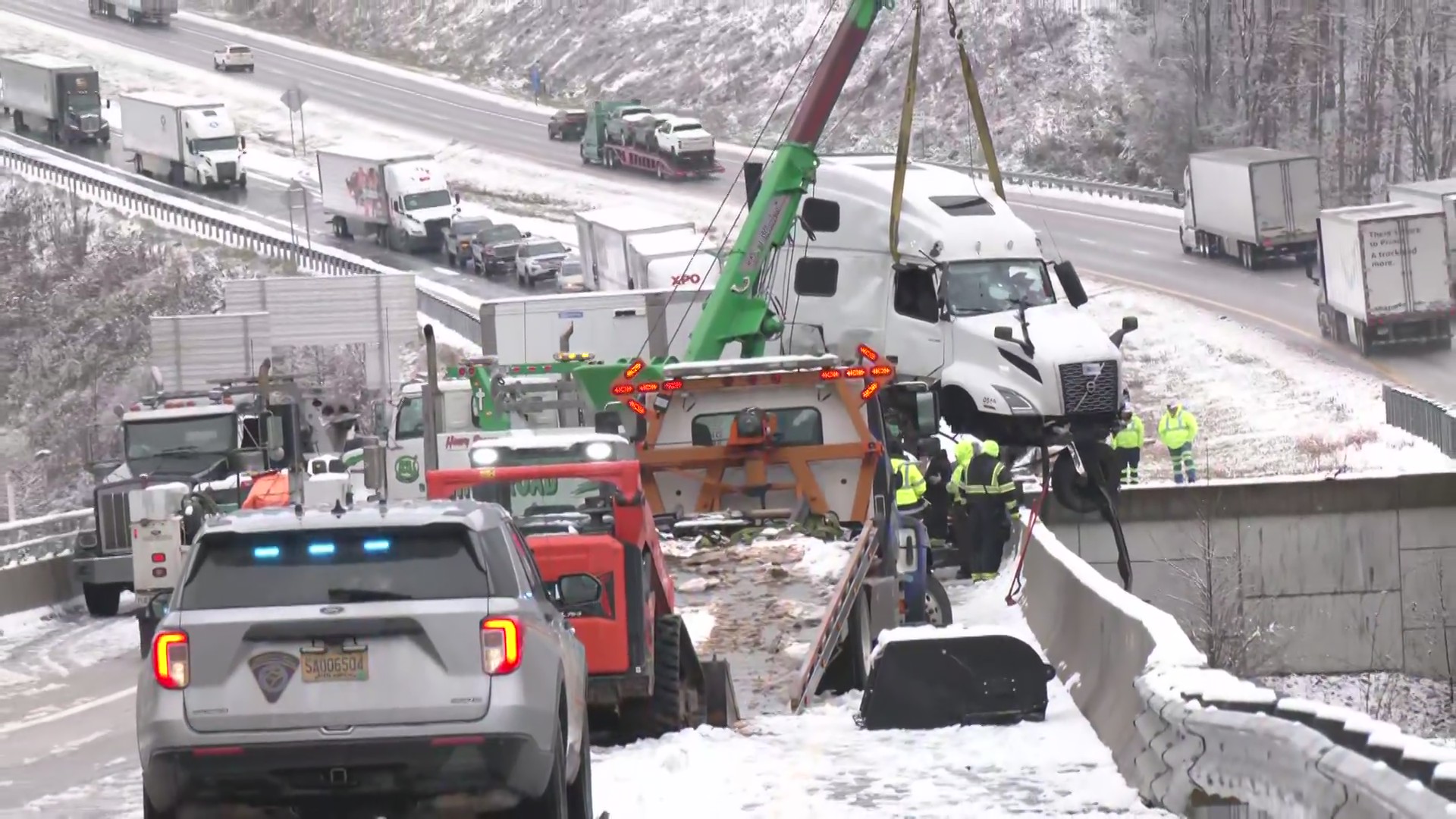 Driver rescued from tractor-trailer hanging over bridge on US 35 in ...